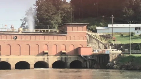 A pan of a dam releasing water. | Stock Video | Pond5