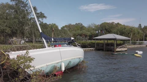 Pan from Damaged Sailboat leaning on th... | Stock Video | Pond5