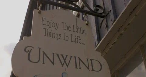 Pan down from a shop sign to the streets... | Stock Video | Pond5