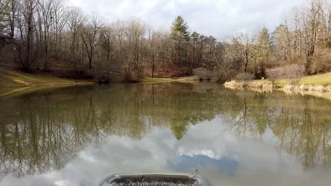 Pan down from sky, forest, and lake to r... | Stock Video | Pond5