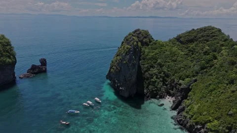 Pan Left Aerial of Rocky Island and Boat... | Stock Video | Pond5