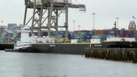 Pan-left shot of stacks of cargo contain... | Stock Video | Pond5