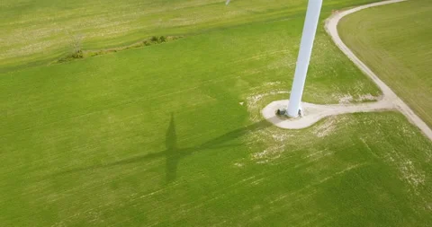 Pan up to reveal a wind turbine. | Stock Video | Pond5