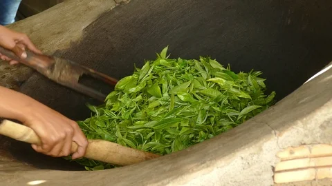 Pan roasting tea leaves for fixation | Stock Video | Pond5