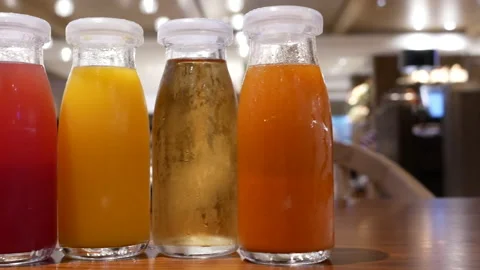 Pan shot of four fresh bottle of juice o... | Stock Video | Pond5