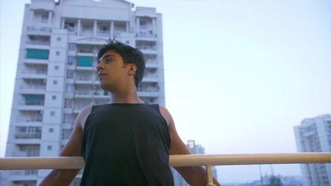 Pan shot of a young Indian man / boy st... | Stock Video | Pond5