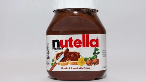 Panning left on a jar of Nutella on a wh... | Stock Video | Pond5