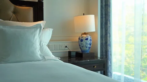 Panning reveal shot of a hotel bed with ... | Stock Video | Pond5
