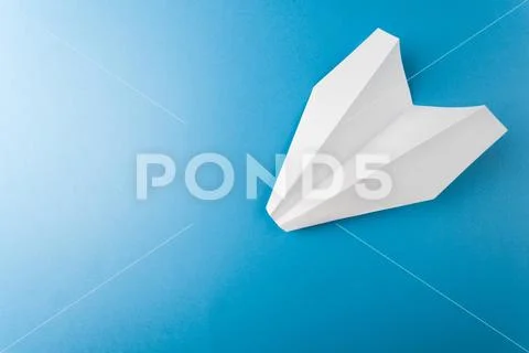 Paper airplane on blue background Stock Photo ~ #88902685