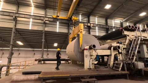 Paper roll carried by an overhead crane ... | Stock Video | Pond5