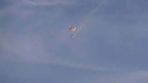 parachuter falling to ground at air show | Stock Video | Pond5