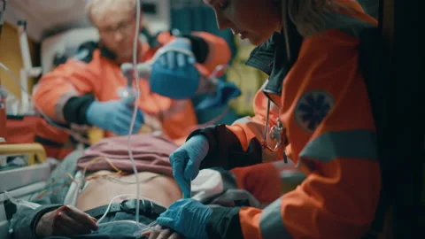 Paramedic Injecting a Shot to Patient in... | Stock Video | Pond5