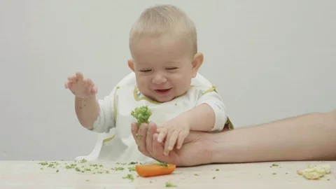 Parent hand offer food to baby, smiling ... | Stock Video | Pond5