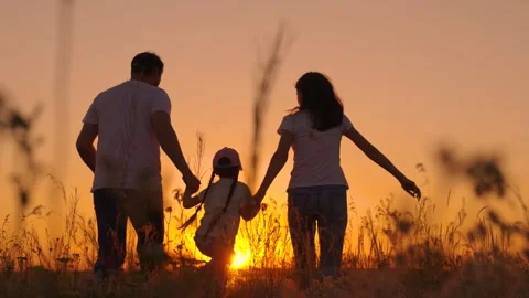 Parents, child are walking in park at su... | Stock Video | Pond5