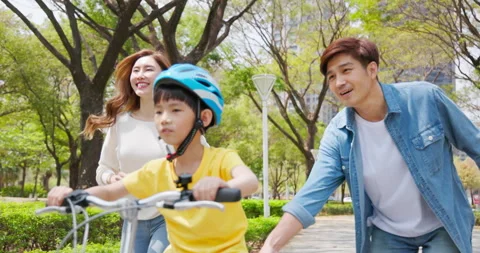 parents educate child bike practice | Stock Video | Pond5