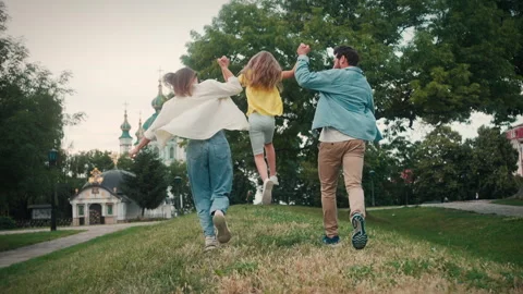 Parents run holding hands lifting daught... | Stock Video | Pond5