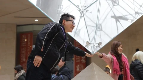 Paris, tourists touch reverse pyramid at... | Stock Video | Pond5