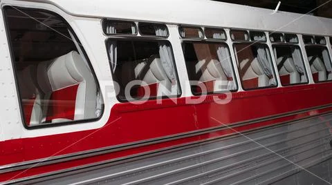 Photograph: Part of red retro bus with passenger seats. #83548847
