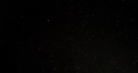 Particles in black screen. Filmed with R... | Stock Video | Pond5
