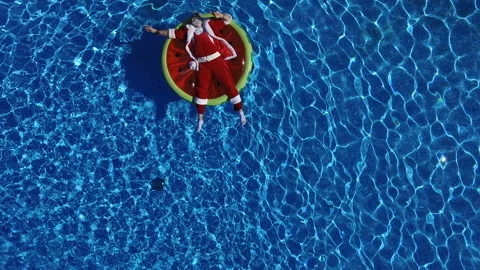 Party Santa in swimming pool on watermel... | Stock Video | Pond5