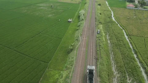 A passenger train passes through the ric... | Stock Video | Pond5