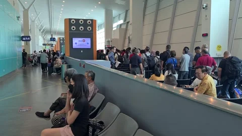 Passengers standing in queue with luggag... | Stock Video | Pond5