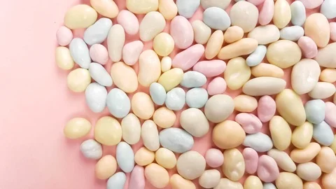 Pastel sweet candy rotating on pink surf... | Stock Video | Pond5