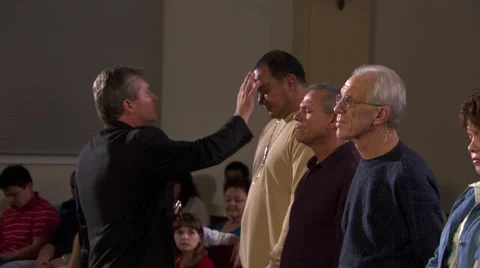 Pastor anointing praying adults | Stock Video | Pond5
