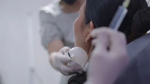 Patient gets ice on face to numb the are... | Stock Video | Pond5