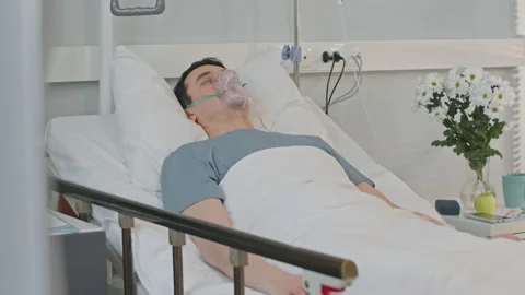 Patient with Oxygen Mask Lying on Hospit... | Stock Video | Pond5