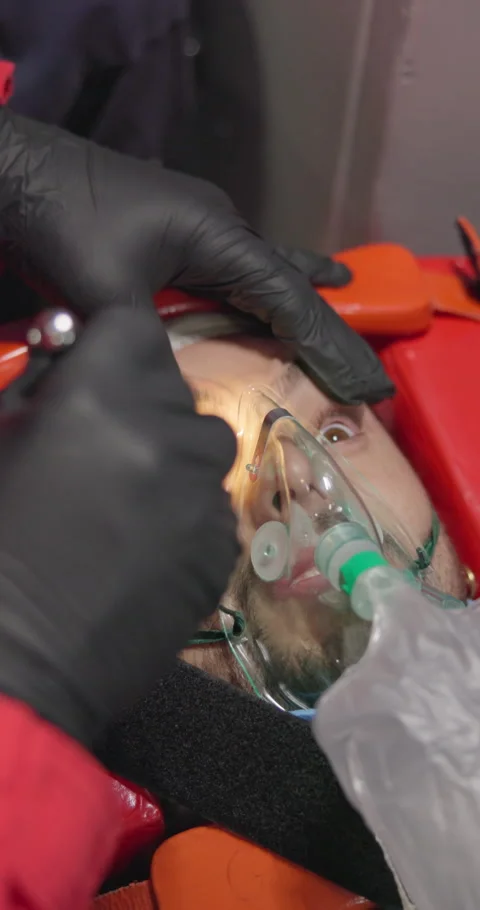 Patient, paramedic and check eyes in amb... | Stock Video | Pond5