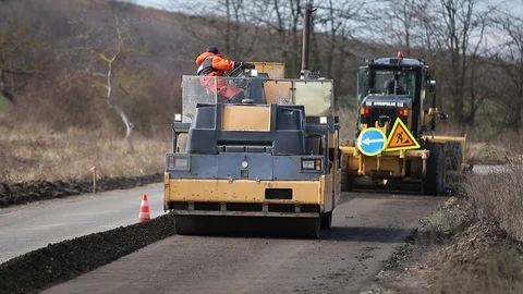 The paver mover on a flat newly made roa... | Stock Video | Pond5
