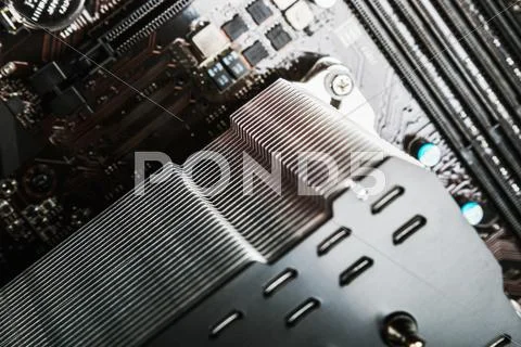 Photograph: PC CPU cooler with heat pipes installed on mainboard #60667337