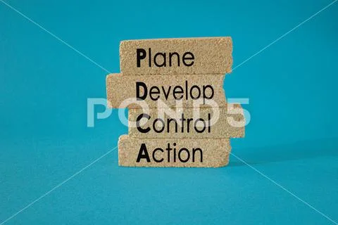 Photograph: PDCA, plan develop control action symbol. Brick blocks with ...