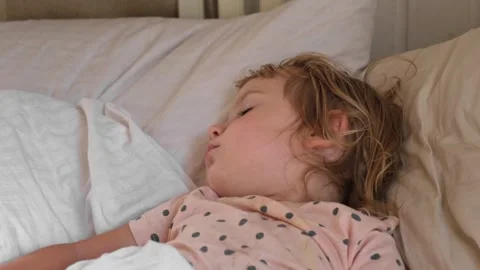 Peaceful adorable baby sleeping on a bed... | Stock Video | Pond5