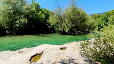 Peaceful rippling current on a river in ... | Stock Video | Pond5