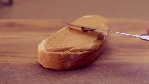 Peanut butter paste spread on bread in s... | Stock Video | Pond5