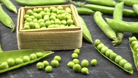 Peas in a box and pea pods, natural back... | Stock Video | Pond5