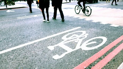 pedestrians crossing road with cycle pat... | Stock Video | Pond5