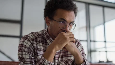 Pensive Man Sitting in Thoughtful Pose i... | Stock Video | Pond5