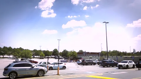 people and cars in a busy parking lot of... | Stock Video | Pond5
