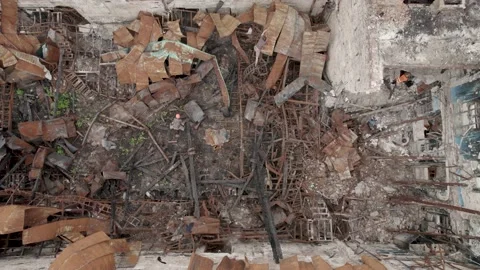 people are clearing rubble on the roof o... | Stock Video | Pond5