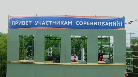 People are in windows on tower with Welc... | Stock Video | Pond5