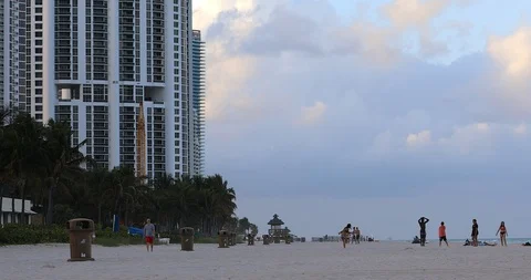 People On The Beach With High Rise Apart... | Stock Video | Pond5