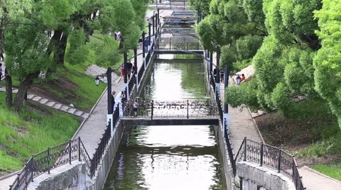 People in beautiful park with water chan... | Stock Video | Pond5