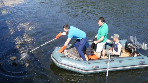 People on a Boat remove plastic pollutio... | Stock Video | Pond5
