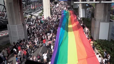 People carry a flag in a parade to kick ... | Stock Video | Pond5