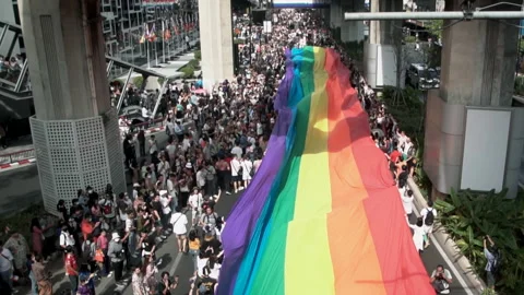 People carry a flag in a parade to kick ... | Stock Video | Pond5
