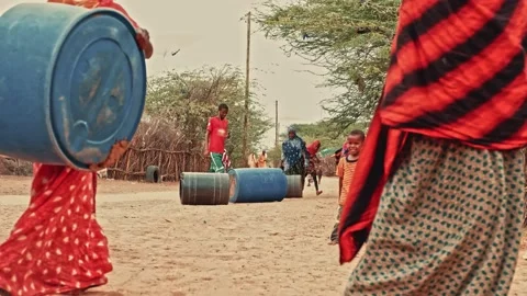 People Carrying Water Barrel in African ... | Stock Video | Pond5