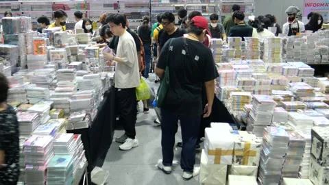 People at cartoon book stall in a book f... | Stock Video | Pond5